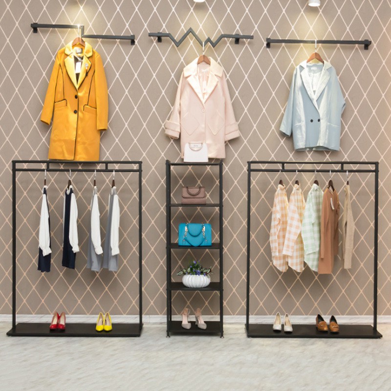 Simple wrought iron clothing store display stand on the wall hanging ...
